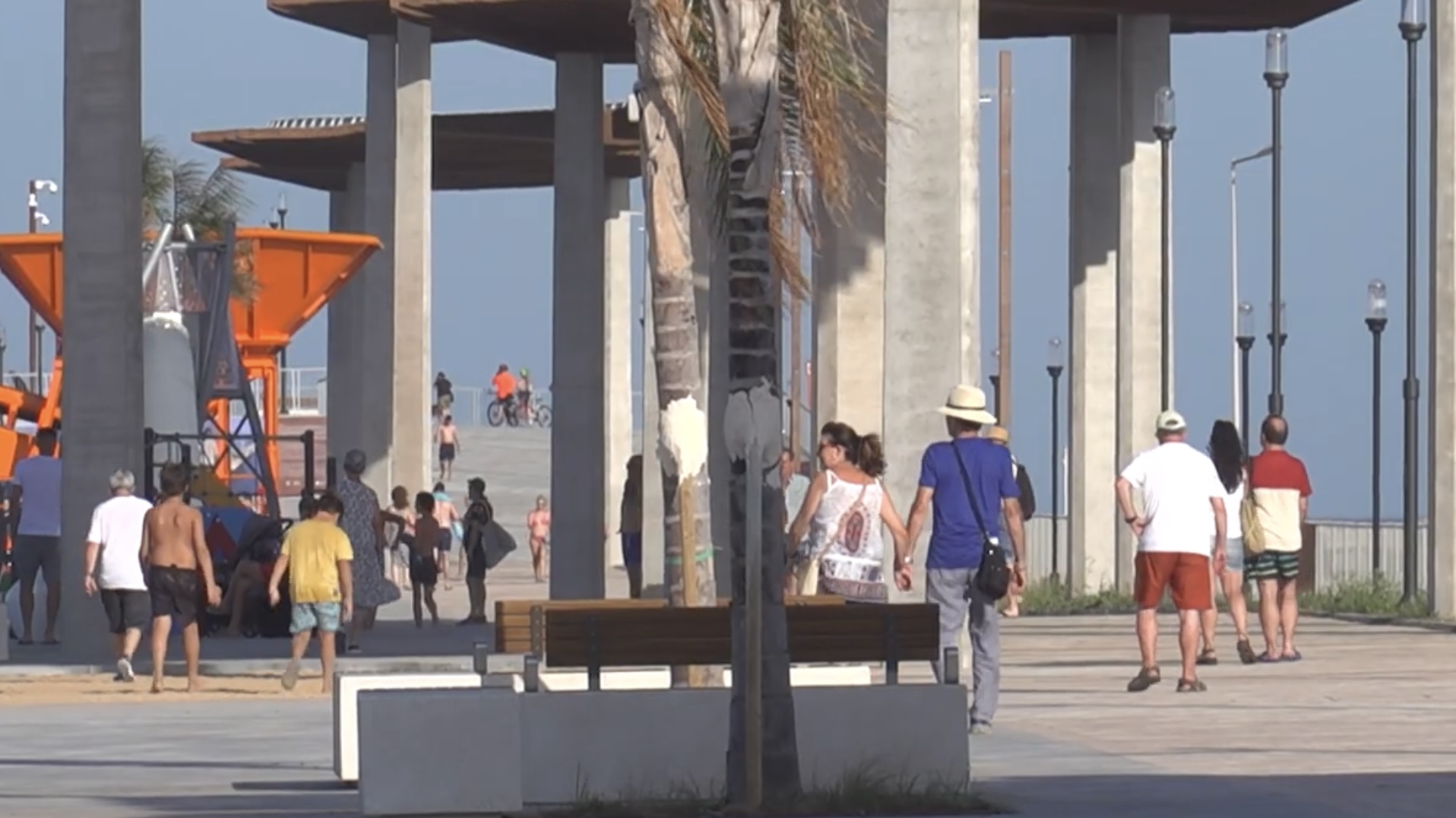 Residents and tourists enjoy the new promenade in the port of Sagunto ...